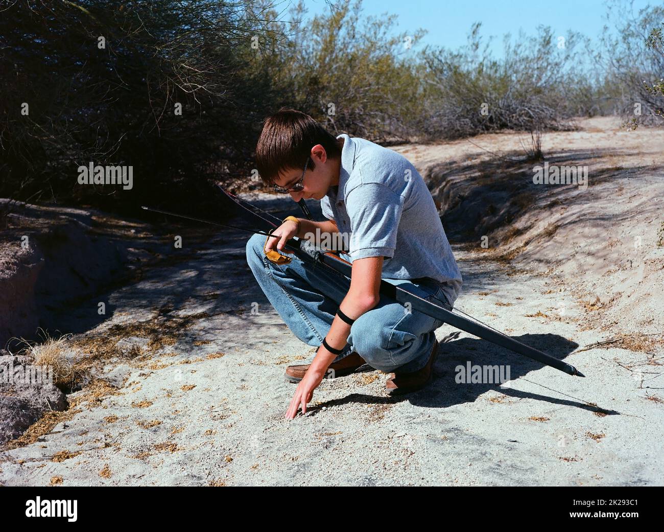 Young Archer Tracking an Animal Stock Photo - Alamy