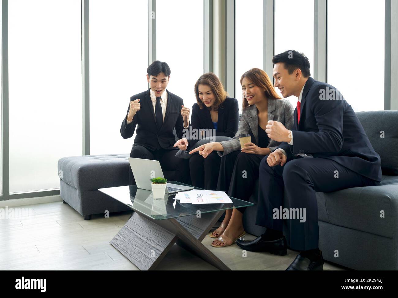 Group of business people in suit looking at report excited by good news ...