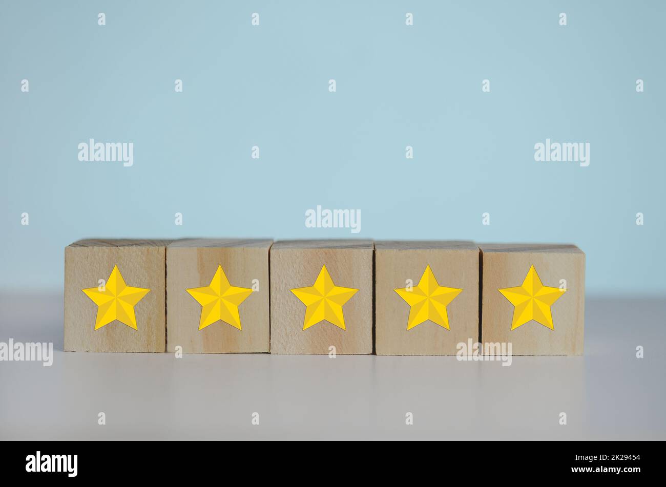 Wooden cubes with yellow star five symbol on background and copy space ...