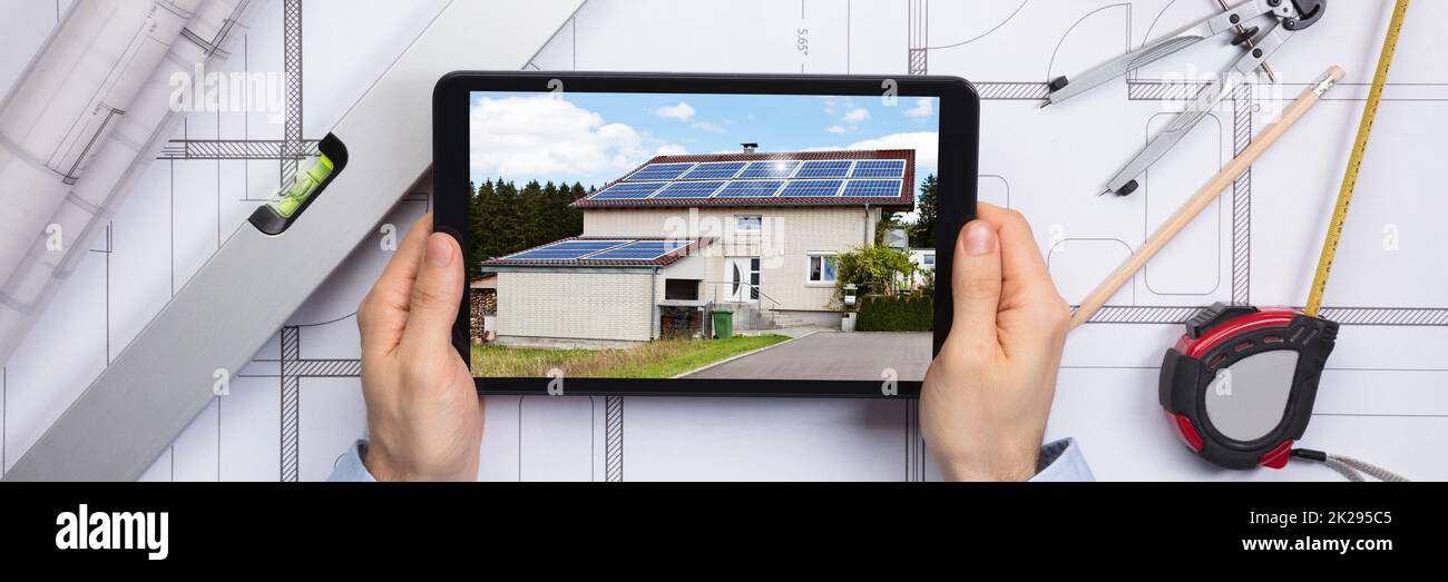 House Solar Energy Panel And Tablet Screen Stock Photo - Alamy