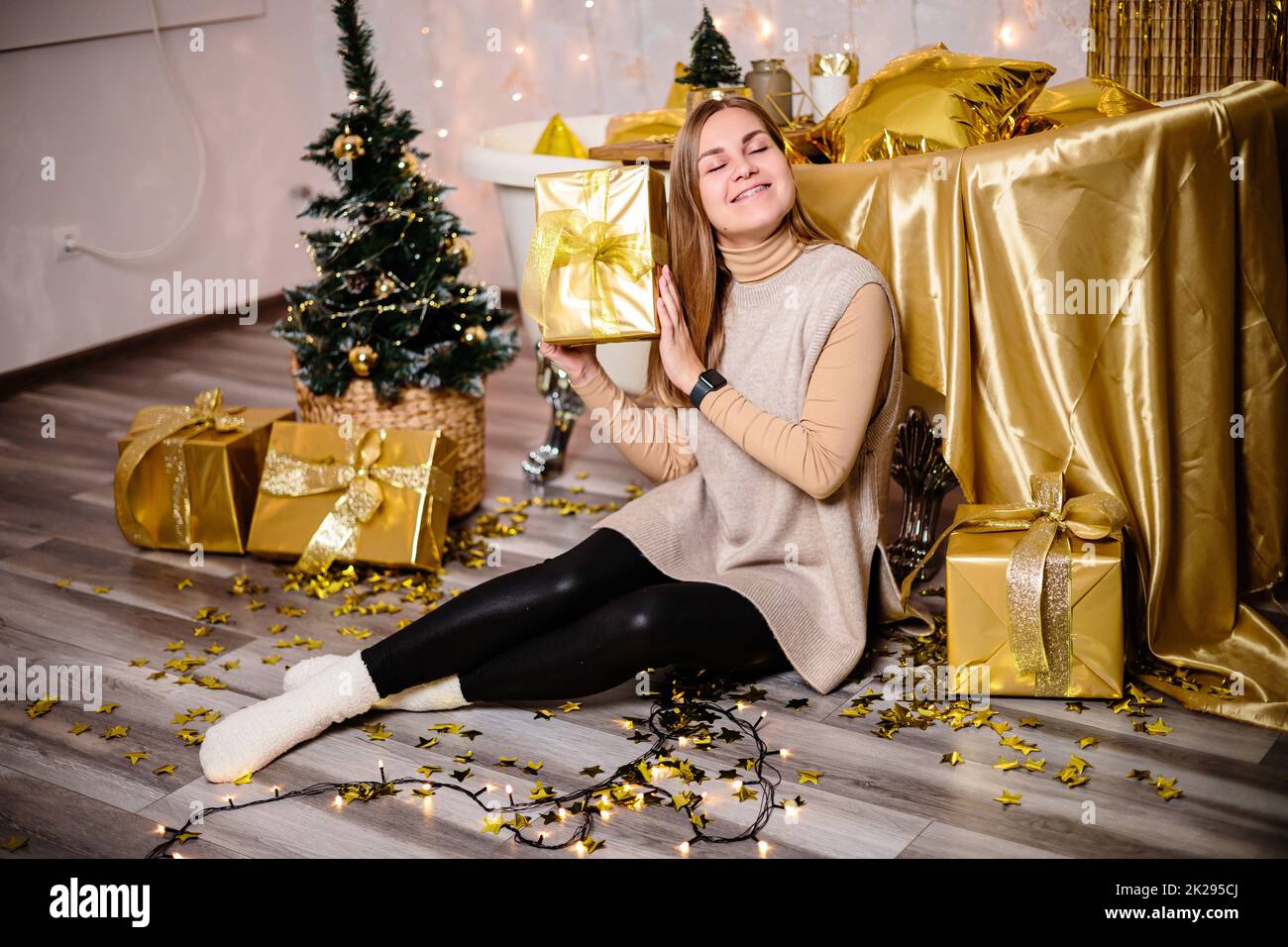 Happy woman in New Year's room. New Year's decoration of the room in ...