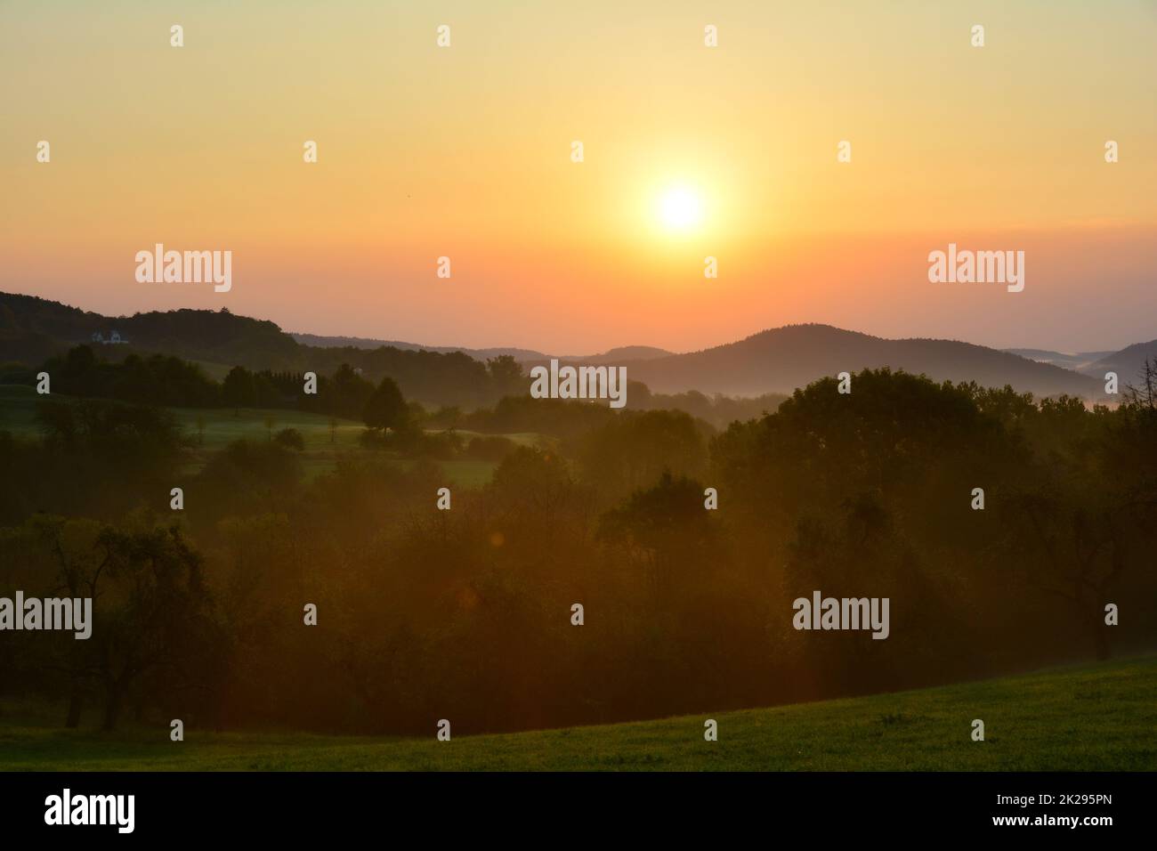 Sun rises over a landscape with morning fog in Germany Stock Photo - Alamy