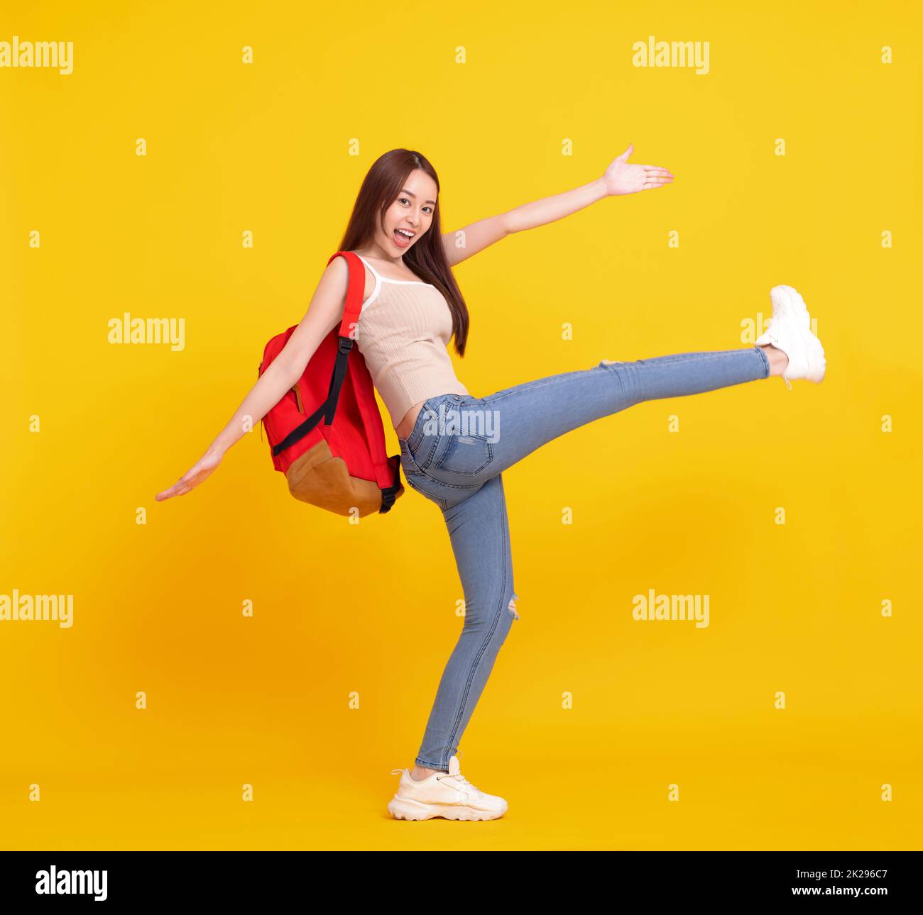 Happy student girl walking and celebrating isolated over yellow Stock ...