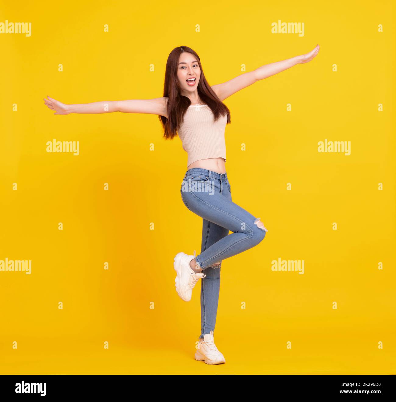 Happy Asian girl jumping and celebrating isolated over yellow Stock ...