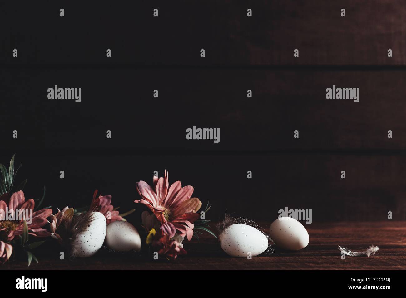 Easter holiday background. Easter eggs, flowers on wooden table. Low ...