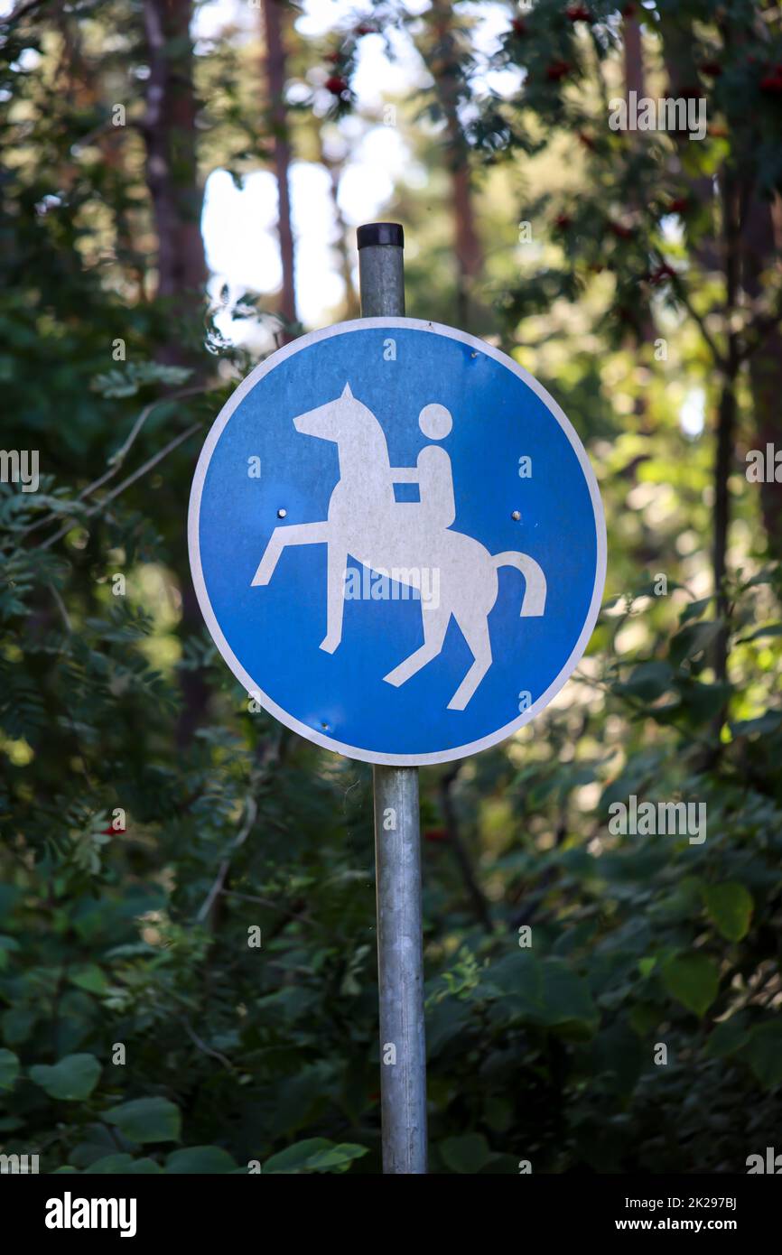 A blue and white sign with a riding horse marks an extra equestrian ...