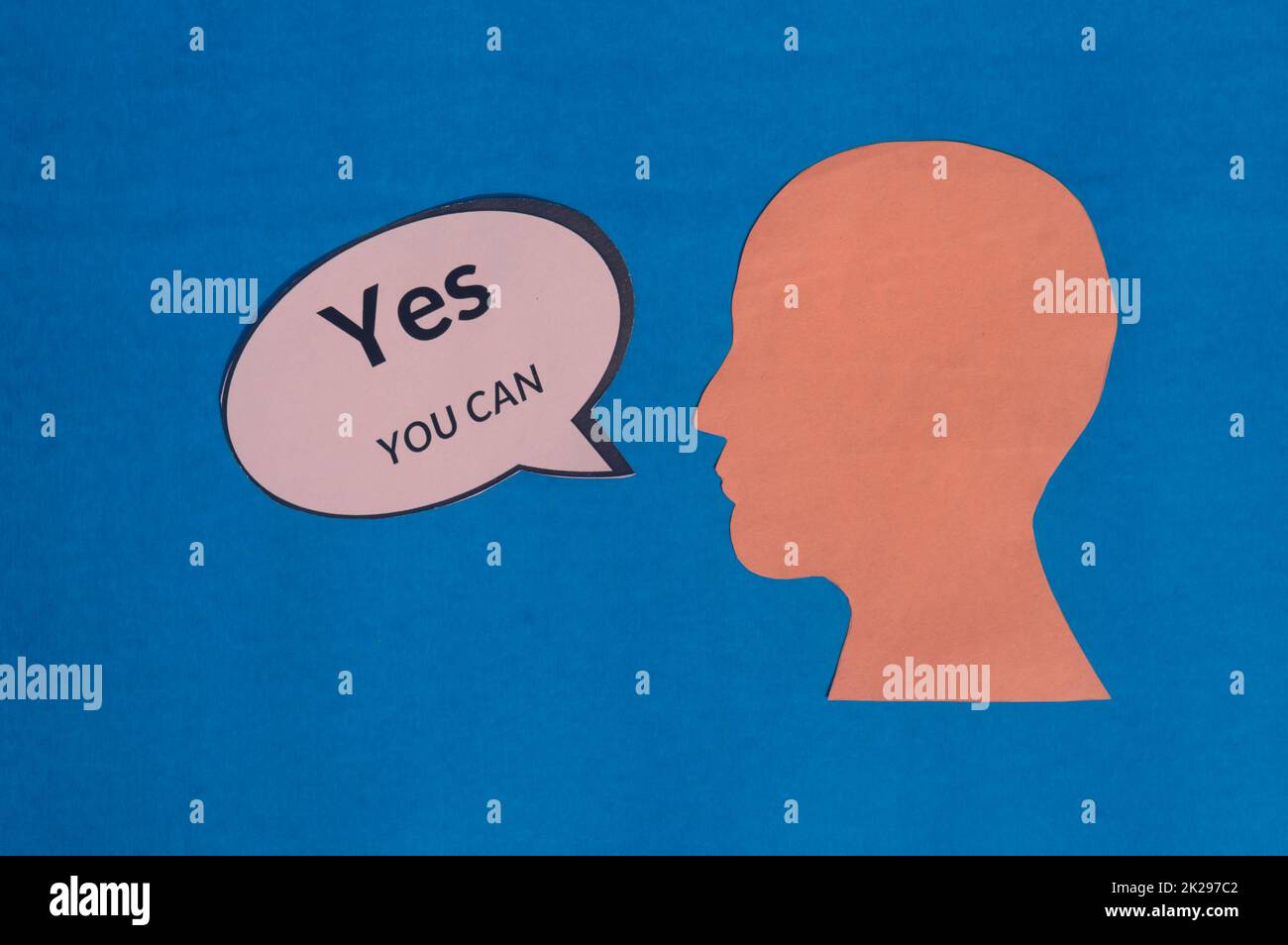Paper human face with motivation text Yes You Can on speech bubble ...