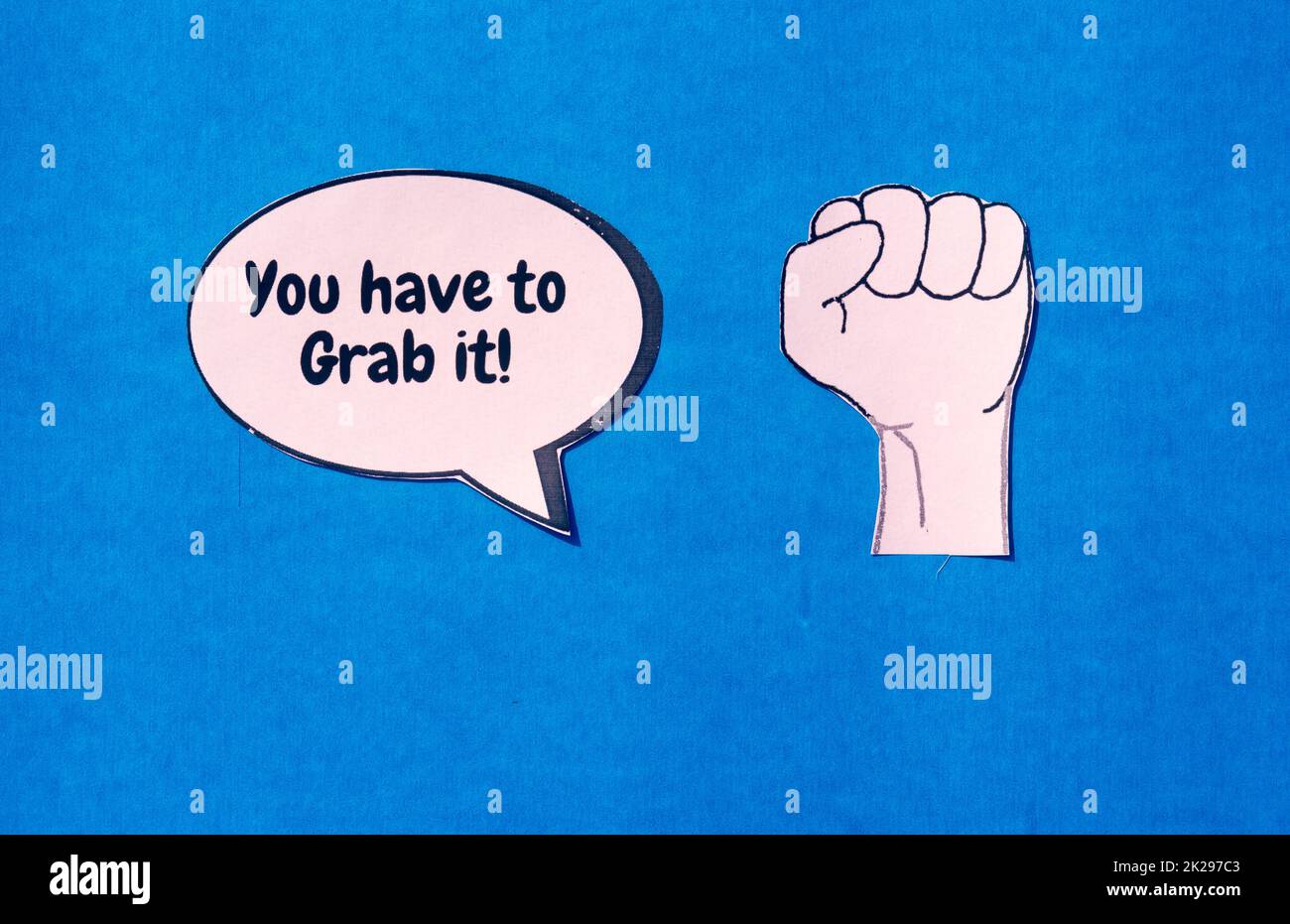 Firm human hand with motivation text on speech bubble isolated on blue ...