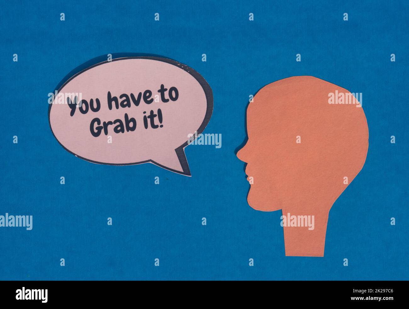 Paper human face with motivation text on speech bubble isolated on blue ...