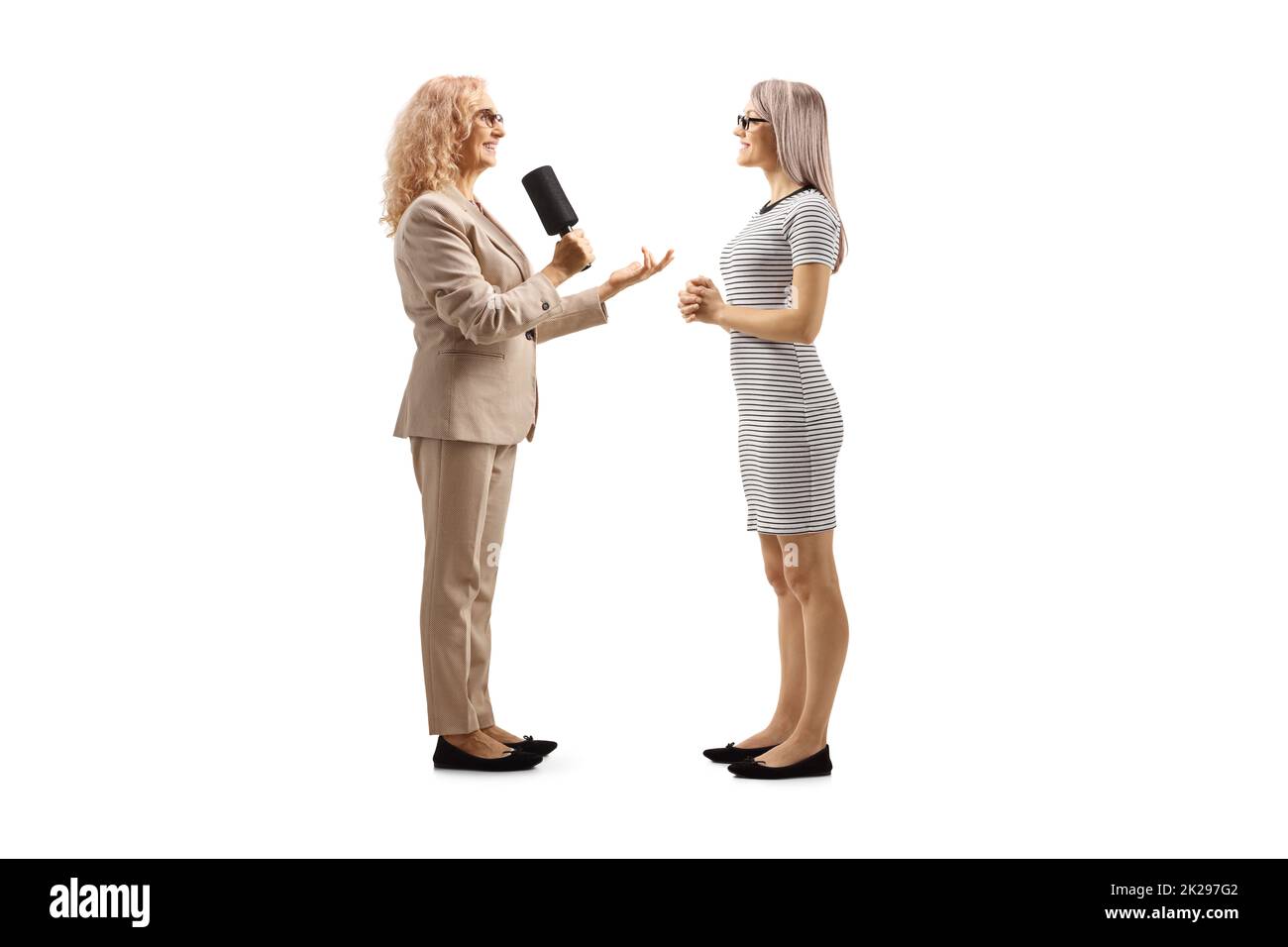 Female reporter interviewing a young casual woman isolated on white ...