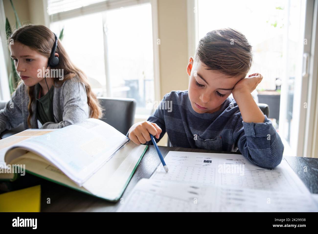 Boy girl doing homework table hi-res stock photography and images - Alamy