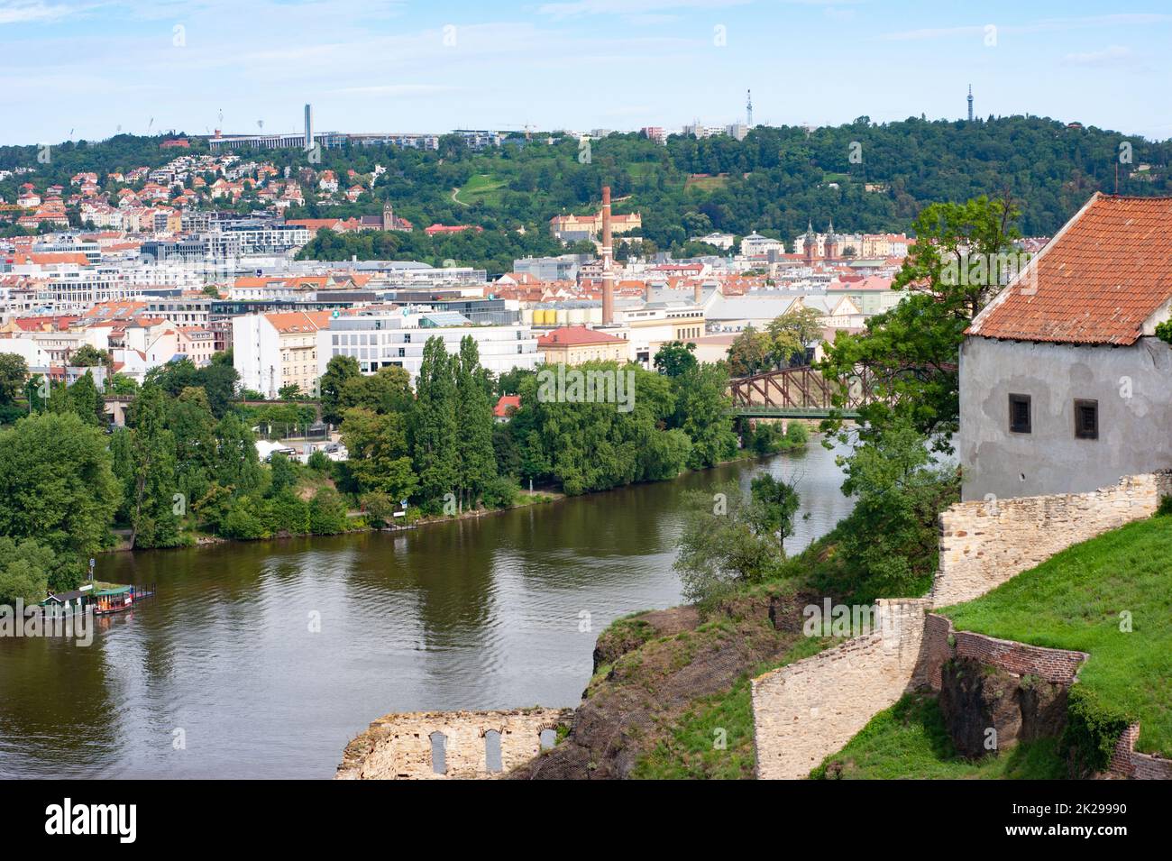 Trees along the Vltava River are seen from the hillside by the old ...