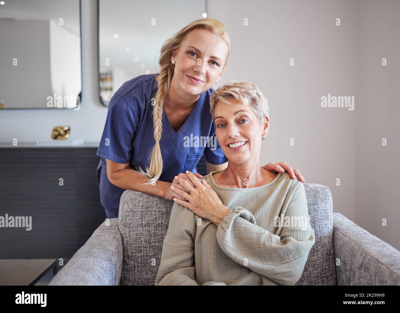 Portrait of elderly woman with a nurse, bonding during checkup at ...
