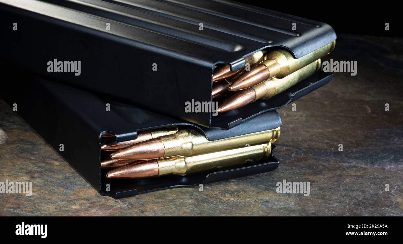 Rifle magazines with bullets loaded on a dark rock suface Stock Photo ...