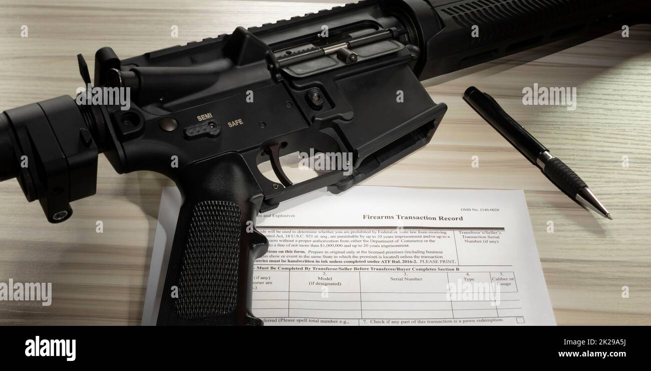 AR-15 with public domain purchase form with pen nearby Stock Photo - Alamy