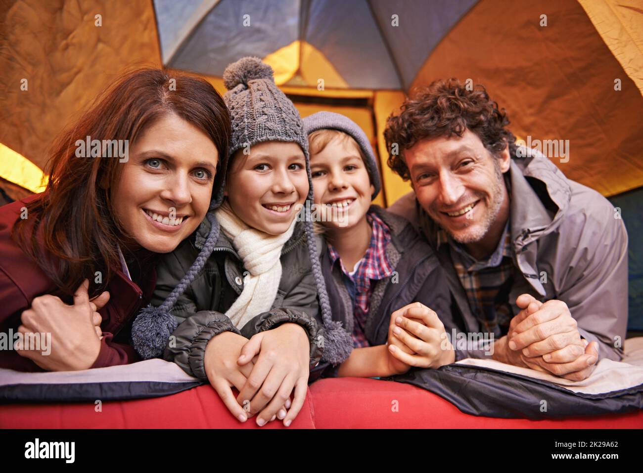 Family camping is family bonding. Portrait of smiling family of four ...