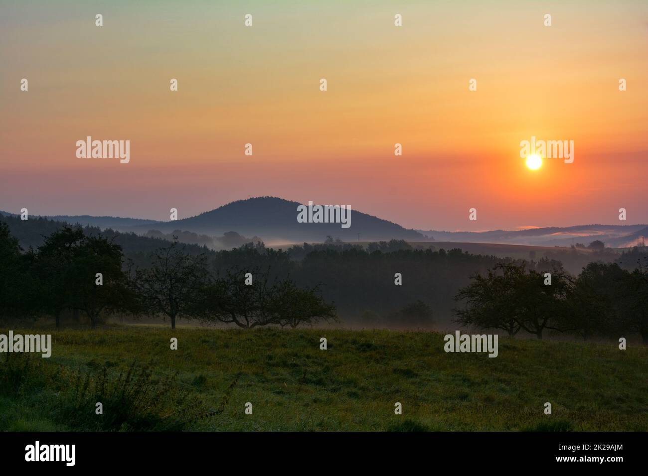 Morning mood at sunrise, hilly nature with fog Stock Photo - Alamy