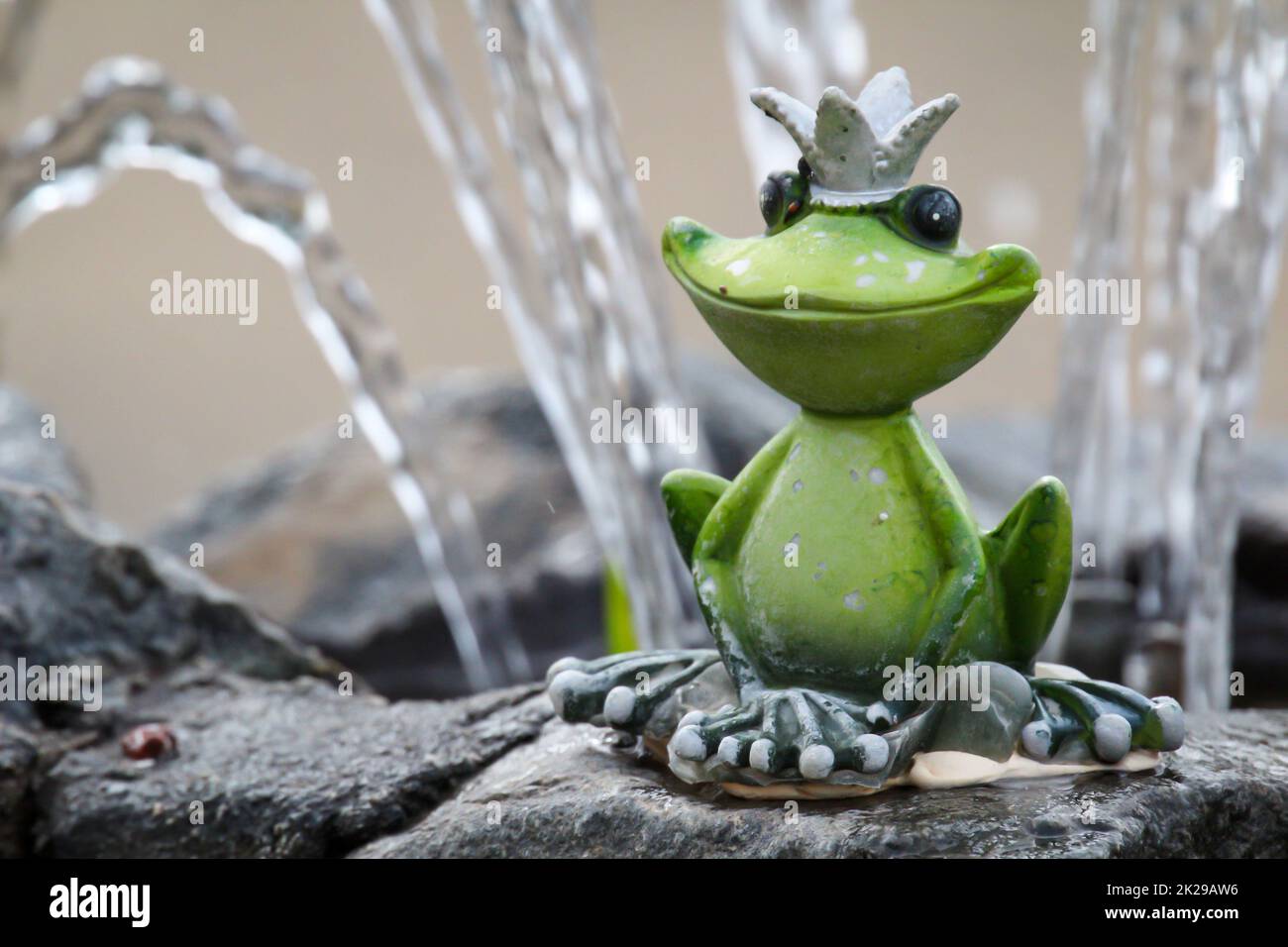 The frog prince sits on a fountain Stock Photo - Alamy