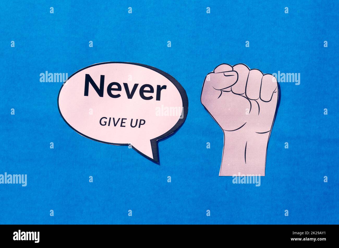 Firm human hand with motivation text on speech bubble isolated on blue ...