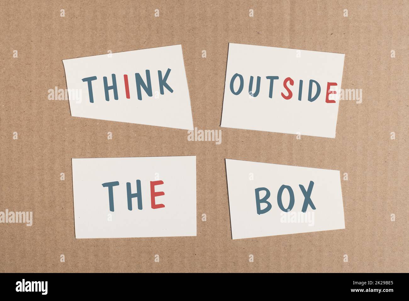 Think outside the box is standing on pieces of white paper, petrol ...