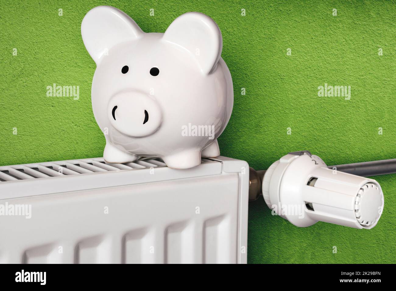 Piggy bank on radiator, increase of heating costs, save energy and ...