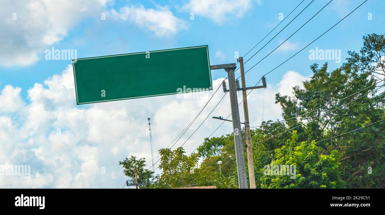 Directional green blank empty road sign in Tulum Mexico Stock Photo - Alamy