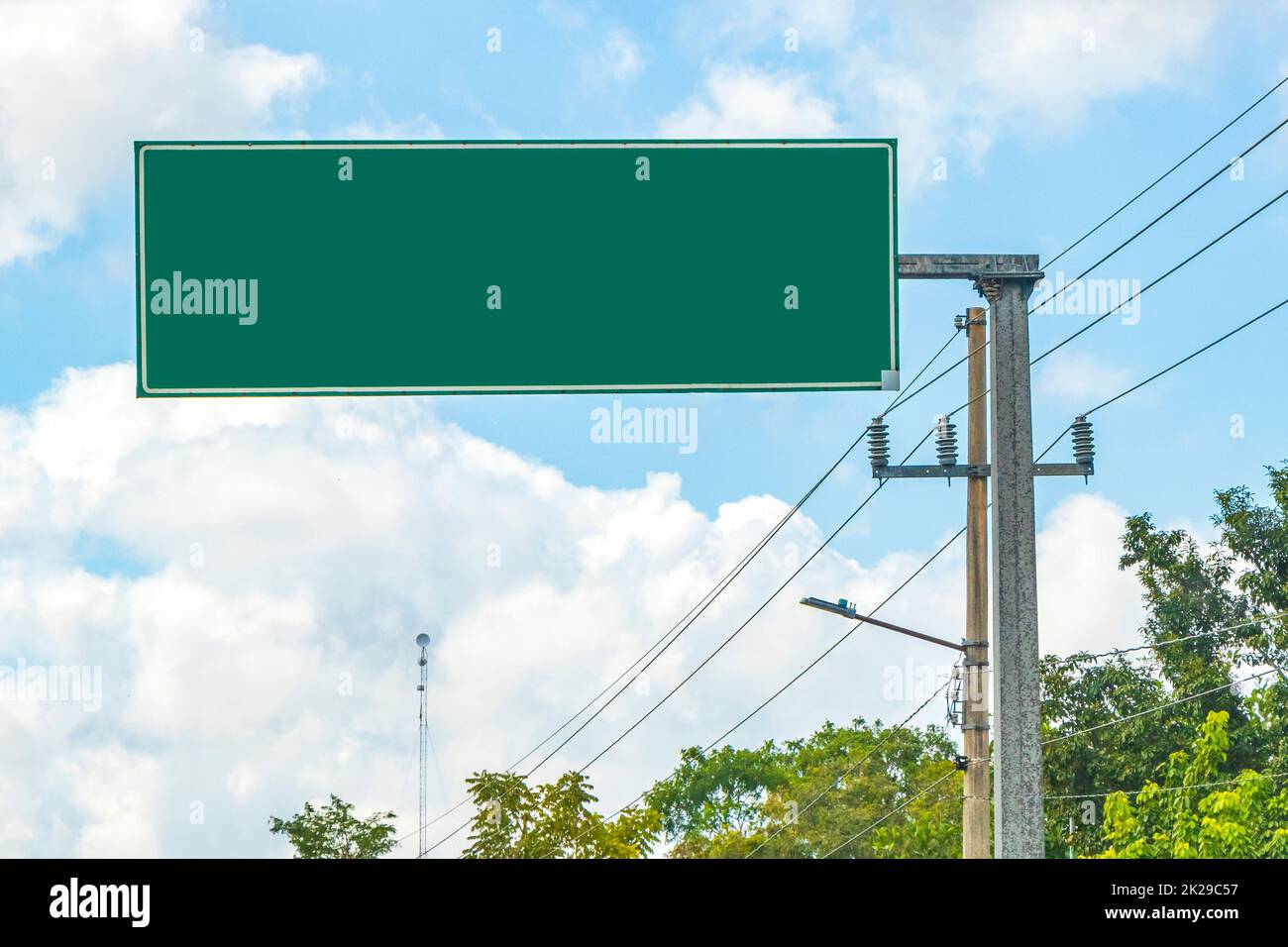 Directional green blank empty road sign in Tulum Mexico Stock Photo - Alamy
