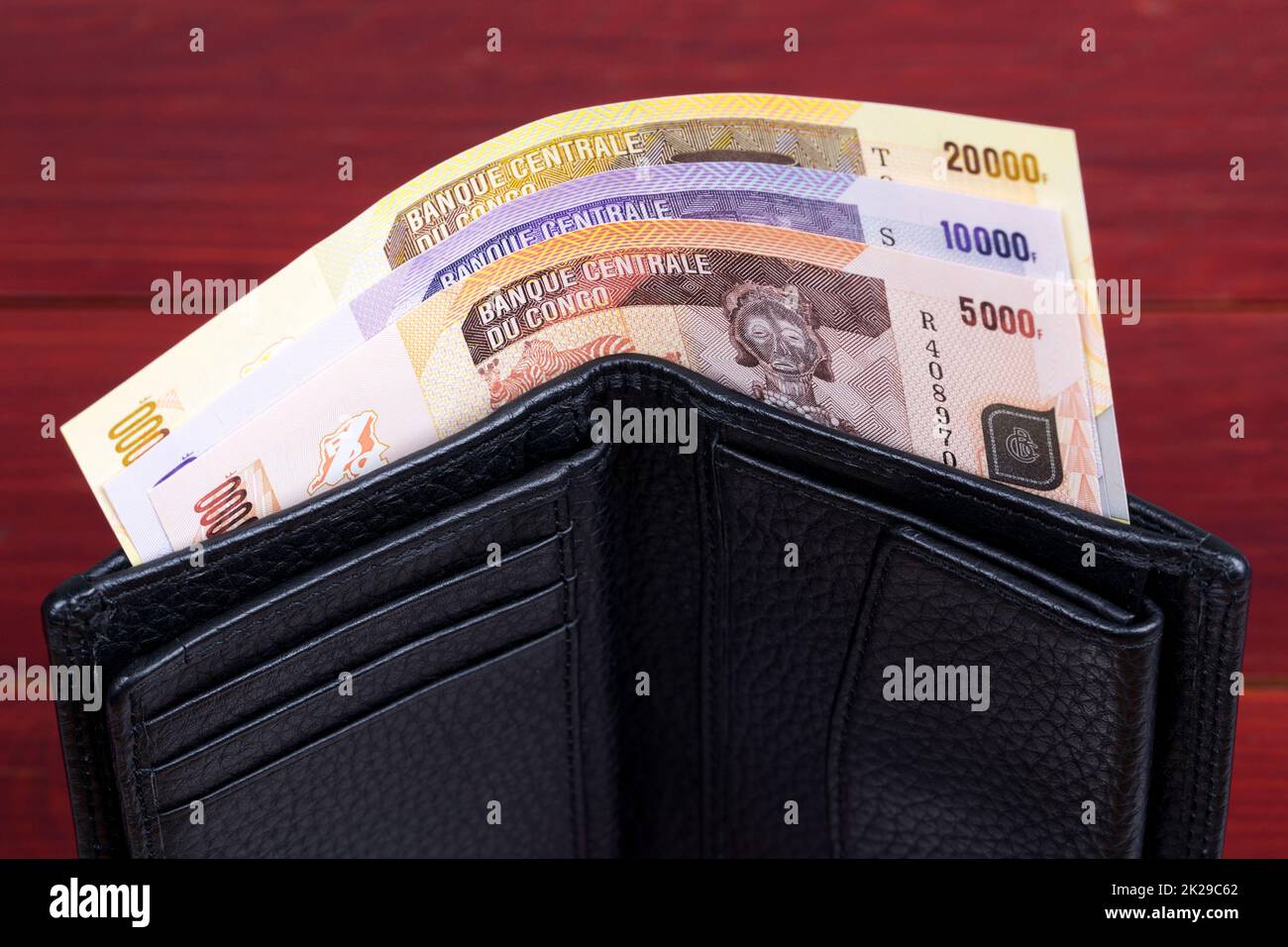 Congolese money in the black wallet Stock Photo - Alamy