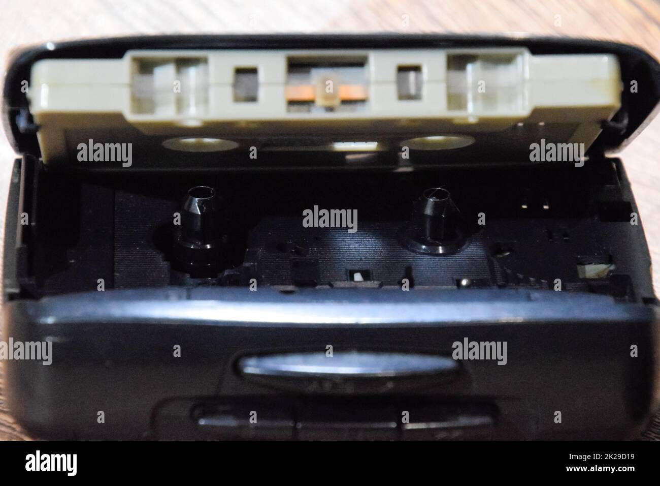 Retro audio cassettes next to a portable player to play compact ...