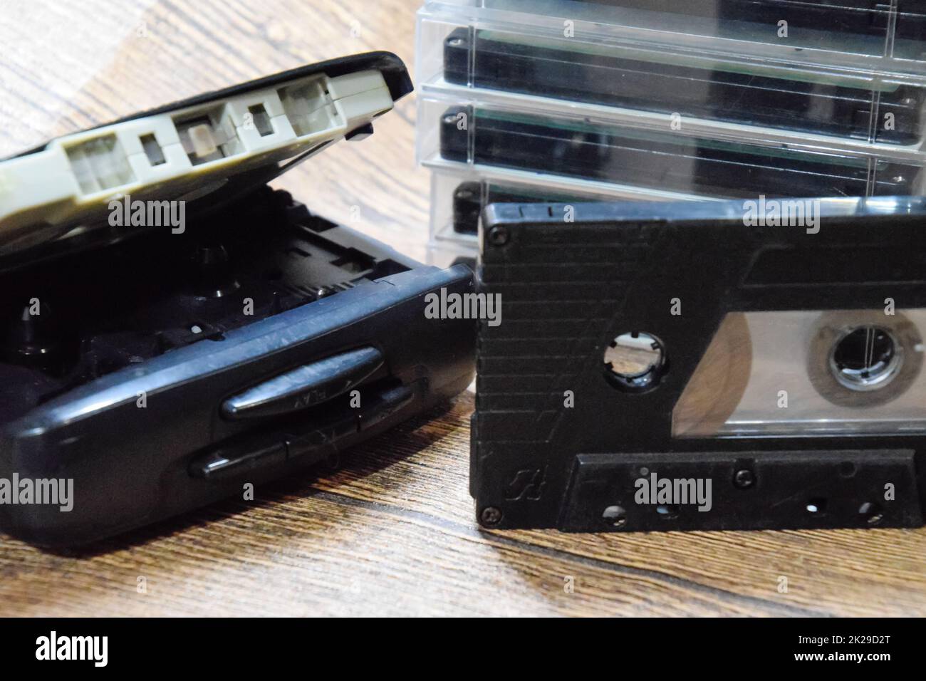 Retro audio cassettes next to a portable player to play compact ...