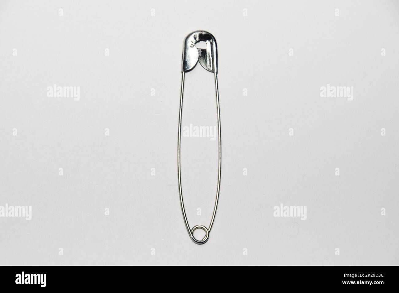 Pin on white background. pin for fastening clothes Stock Photo - Alamy