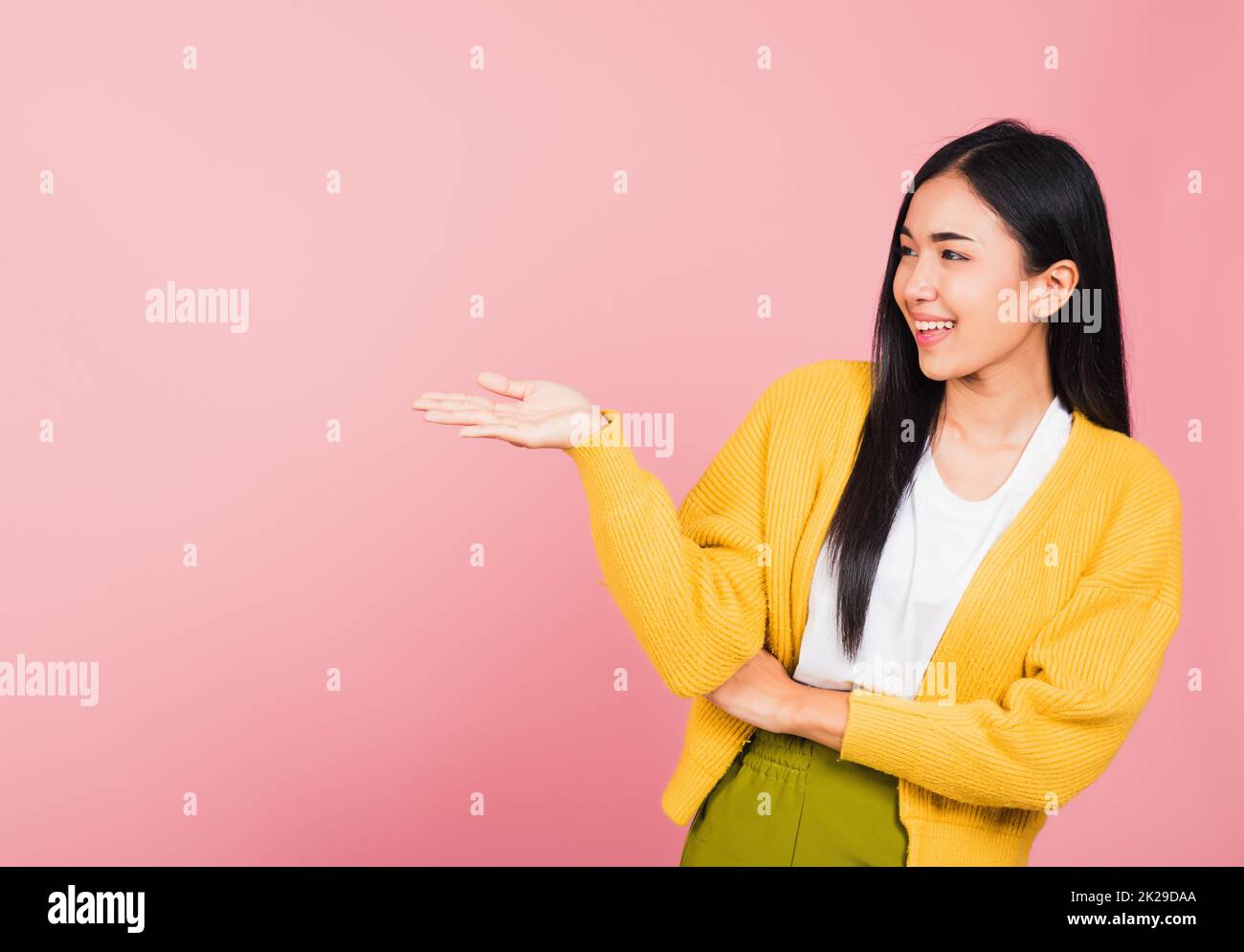 woman smile standing presenting product holding something on palm away ...