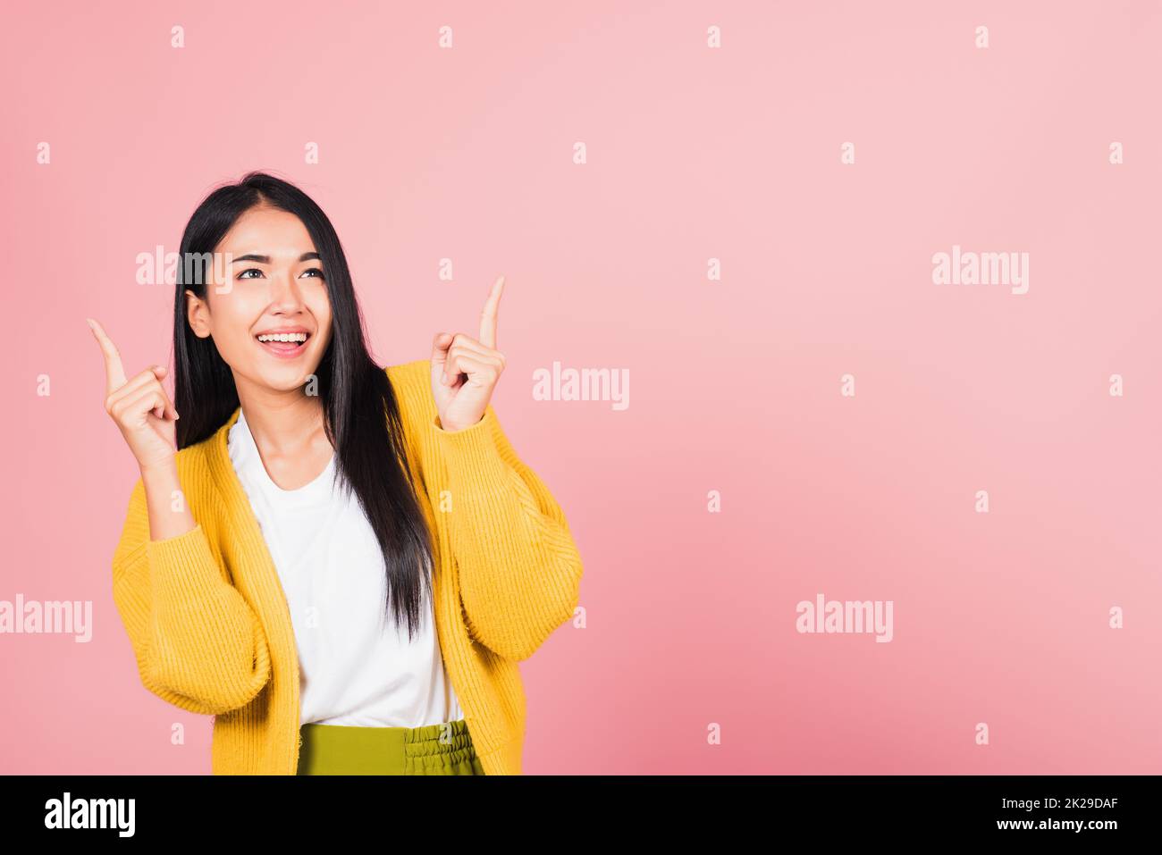woman standing makes gesture two fingers point upwards above presenting ...