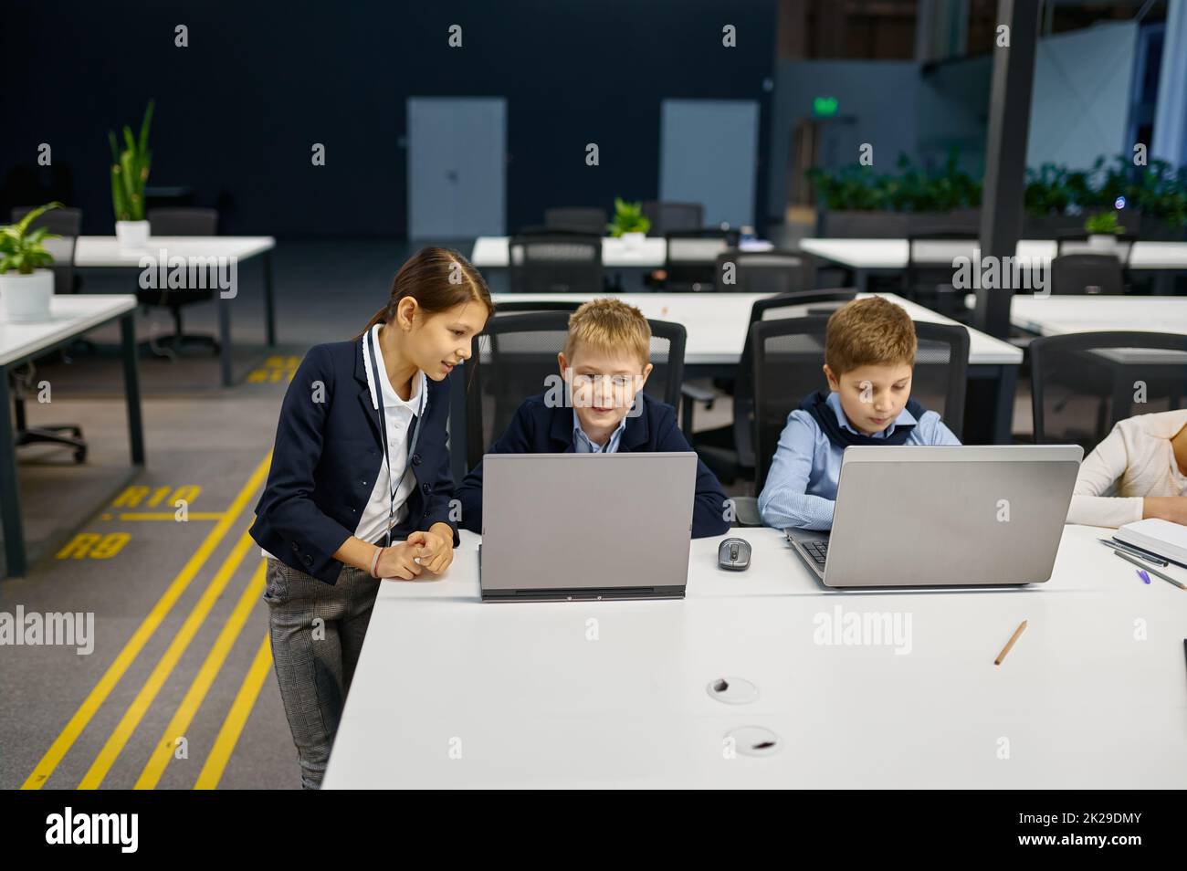Children working on laptop in modern office Stock Photo - Alamy