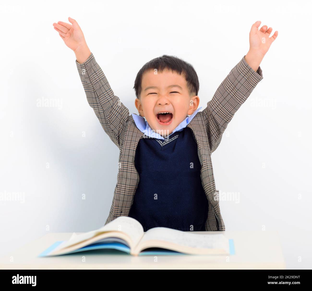 Excited little boy is reading book Stock Photo - Alamy