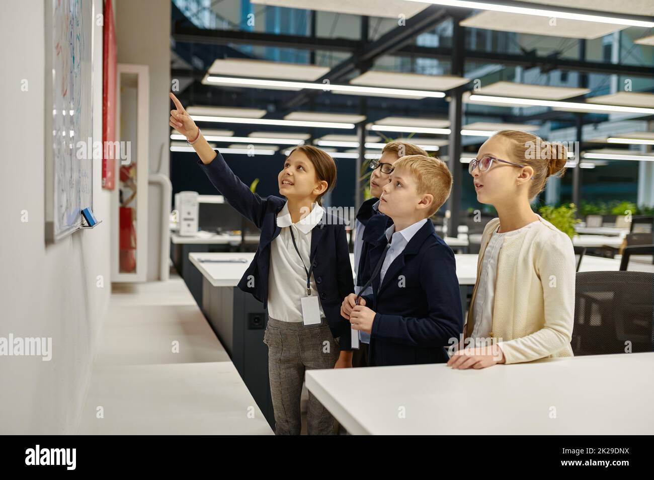 Little creative manager pointing on project board Stock Photo - Alamy