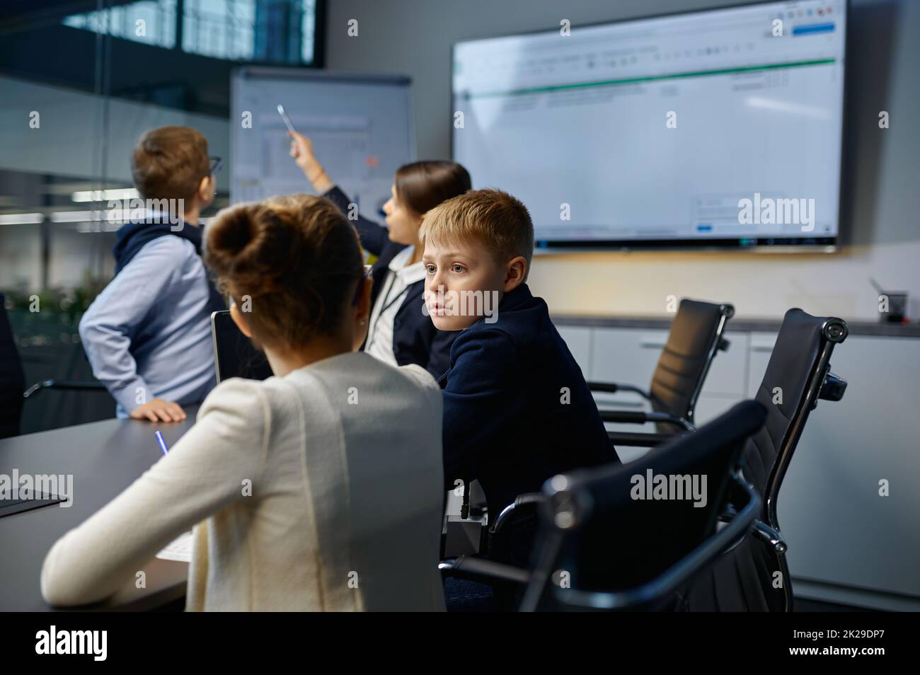 Children employees talking at team office meeting Stock Photo - Alamy