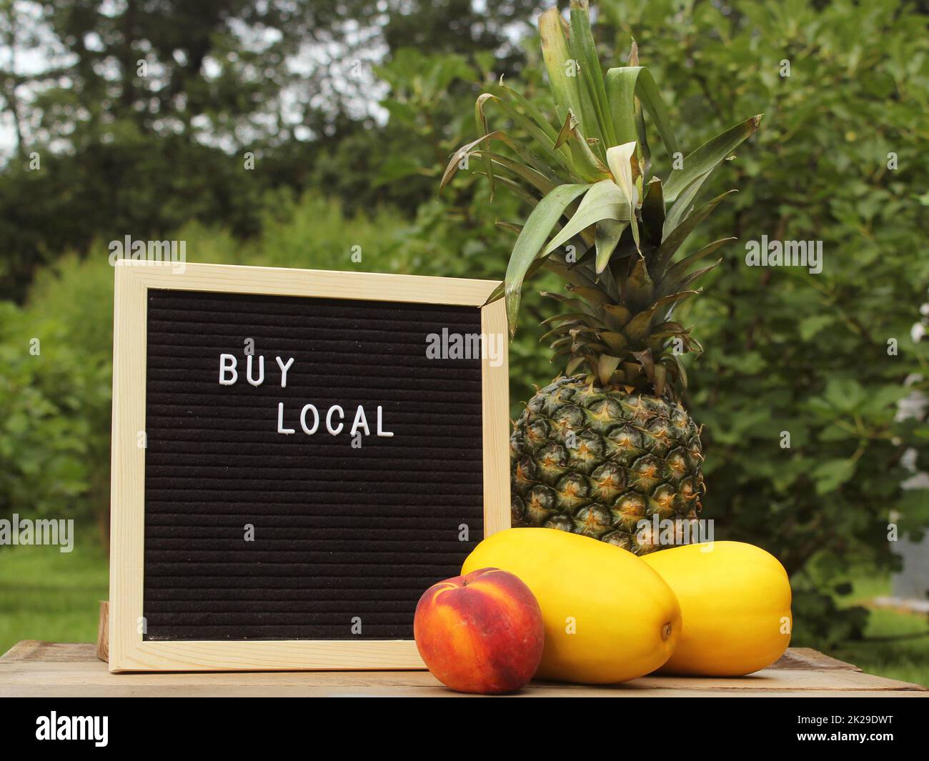 Fresh Pineapple with Asian Melons and Peach on Table With Buy Local ...