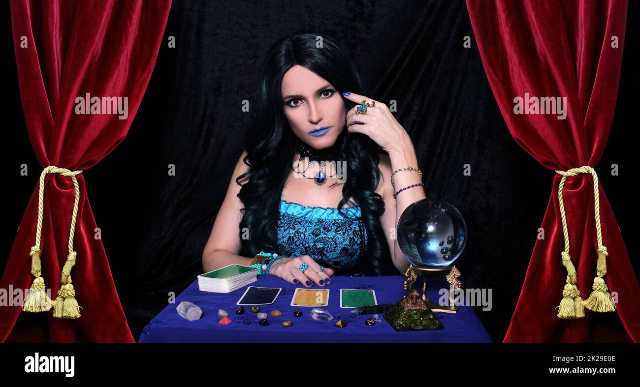 Psychic with Crystal Ball and tarot cards in Red Velvet Tent Stock ...