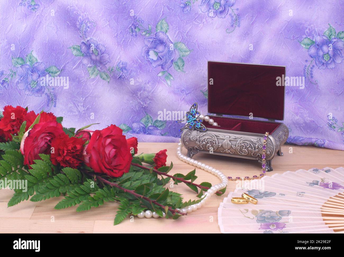 Red Roses with Wedding Bands and Jewelry Box Stock Photo - Alamy