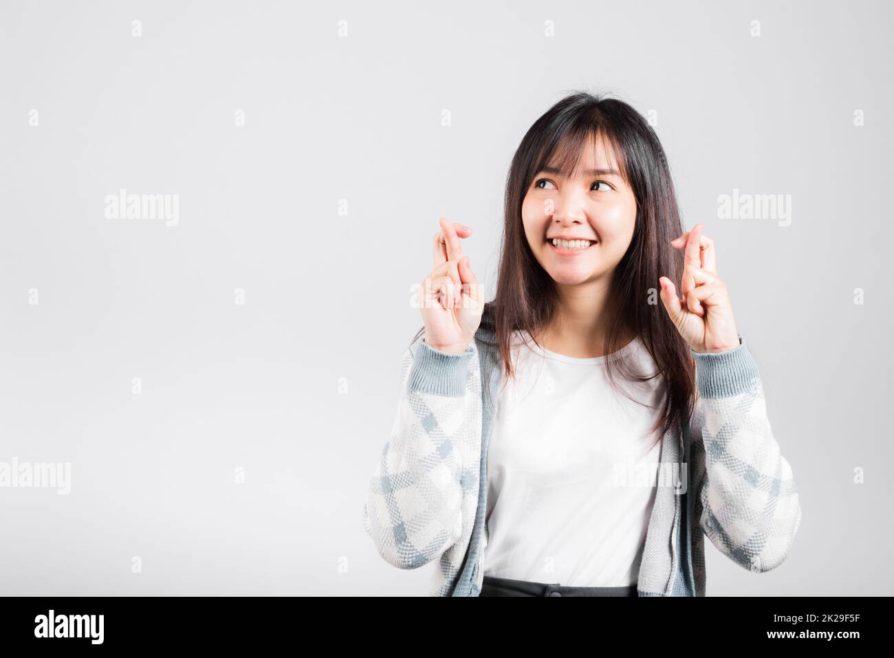 Happy woman have superstition her holding fingers crossed for good luck ...