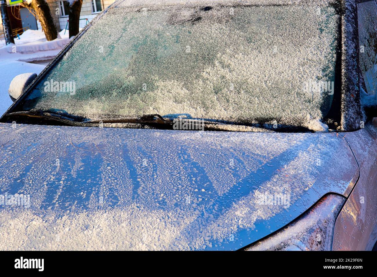 The windshield covered with frost at the car on a sun winter day Stock ...