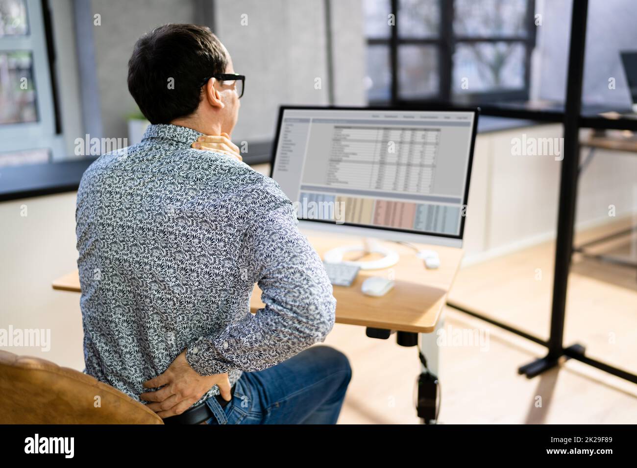Back Pain Bad Posture Man Sitting Stock Photo - Alamy