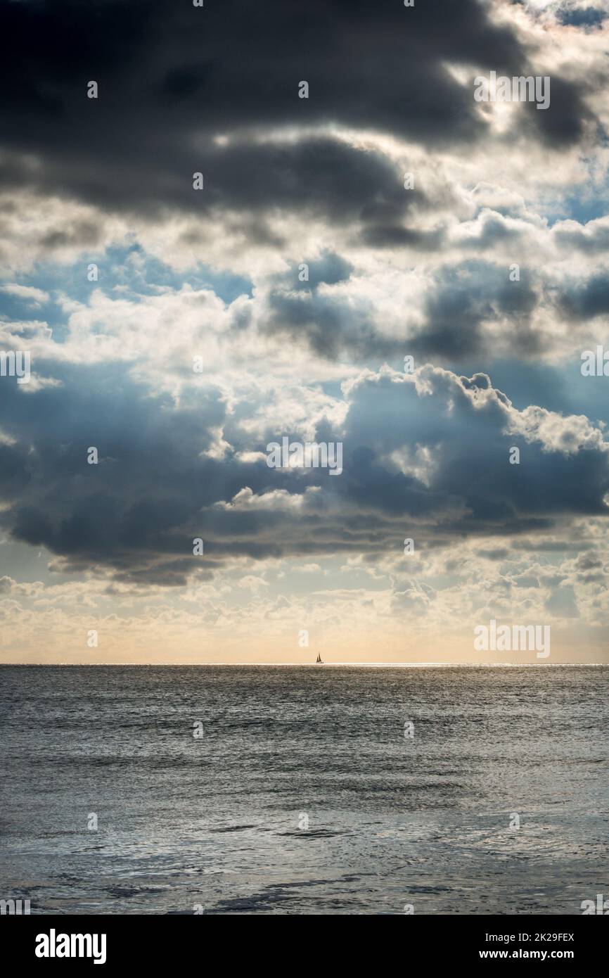 Cloudy seascape view from a beach at sunset Stock Photo - Alamy