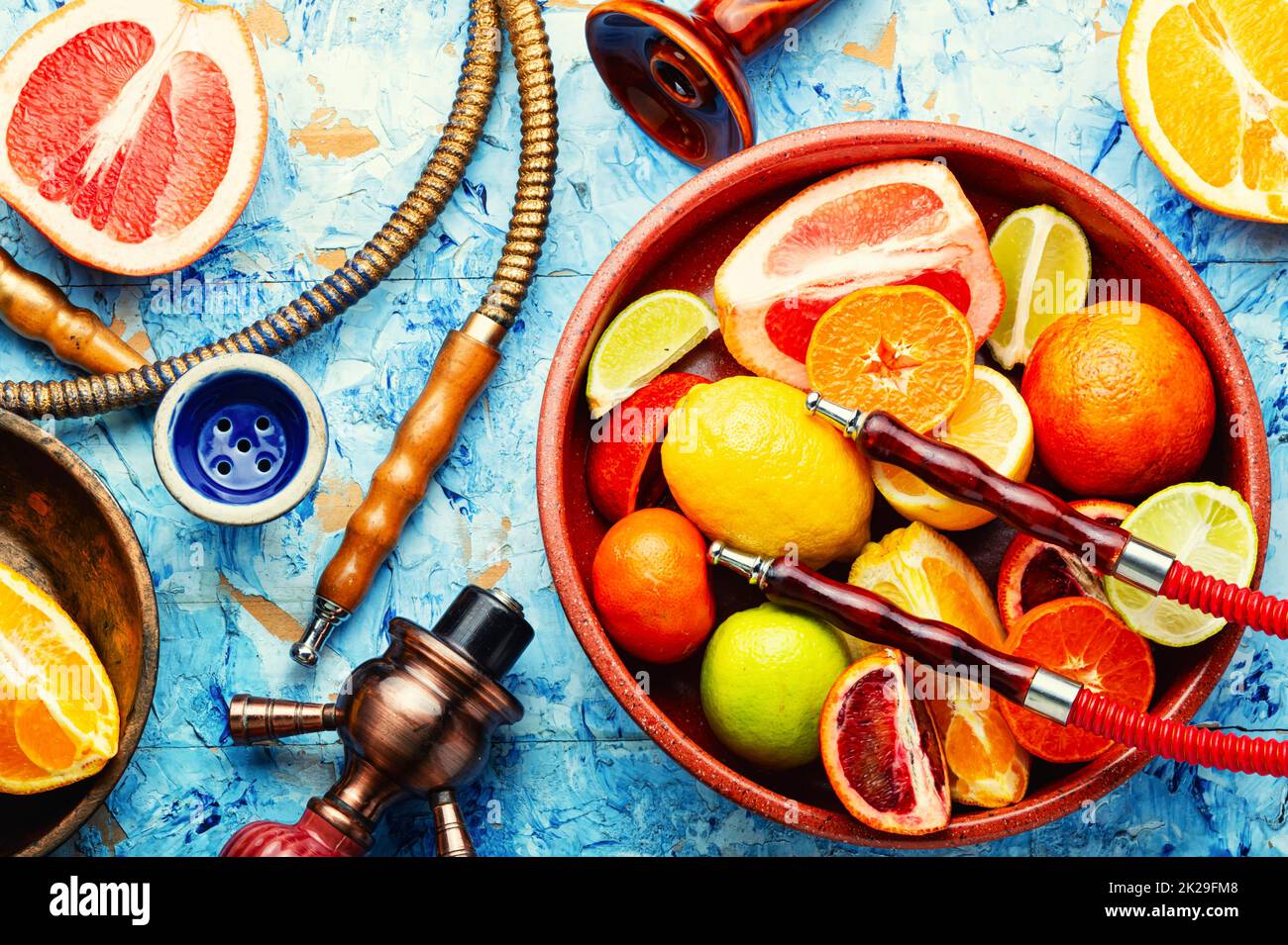 Smoking shisha with citrus fruits Stock Photo - Alamy
