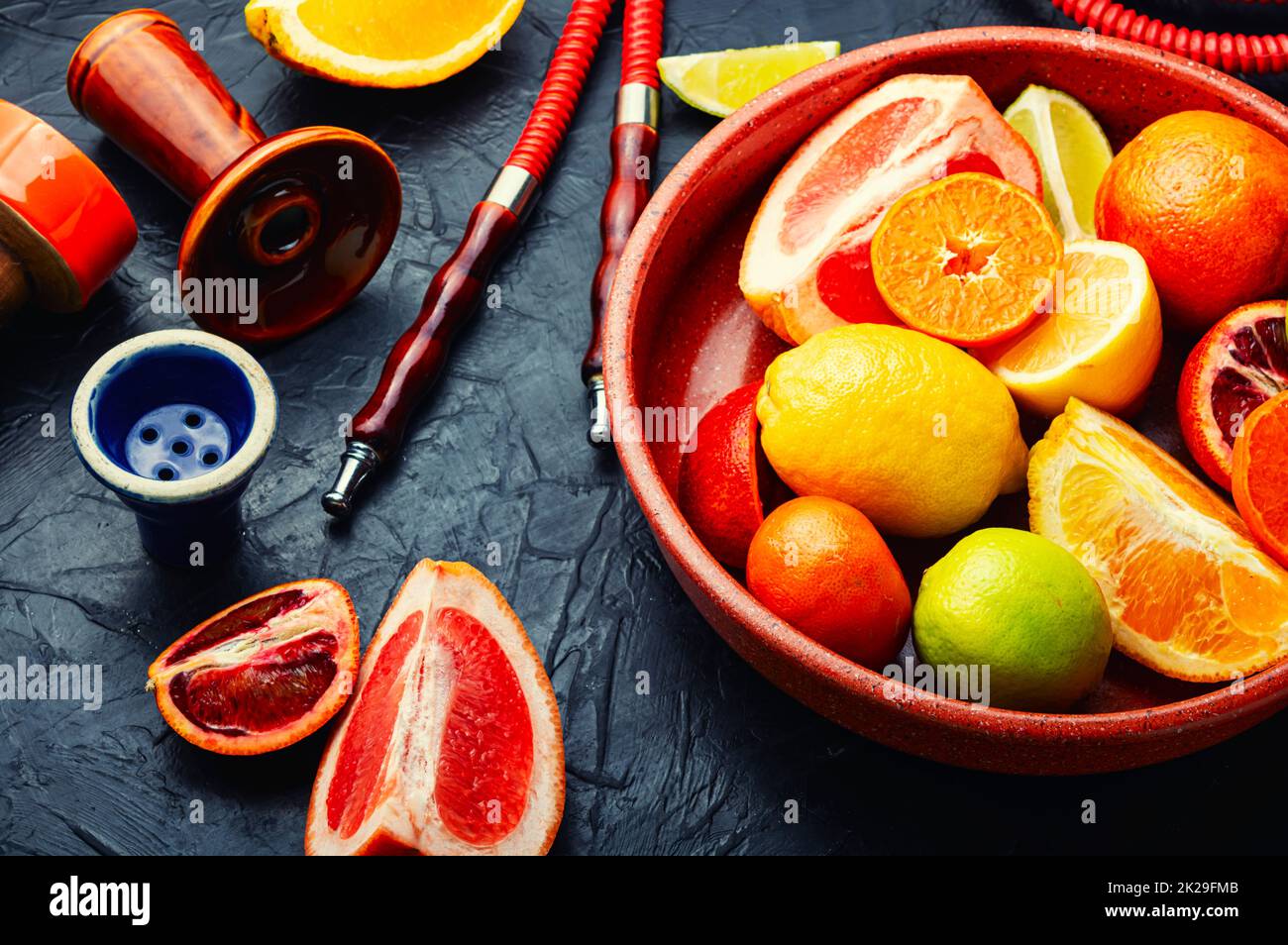Smoking shisha with citrus fruits Stock Photo - Alamy