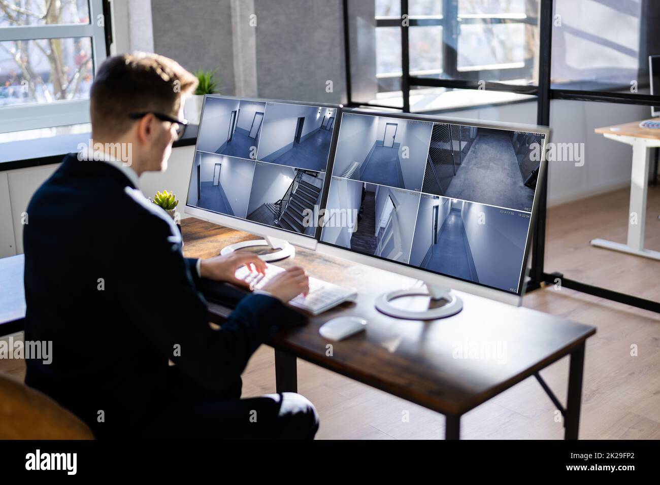 Security System Operator Looking At CCTV Camera Footage Stock Photo - Alamy