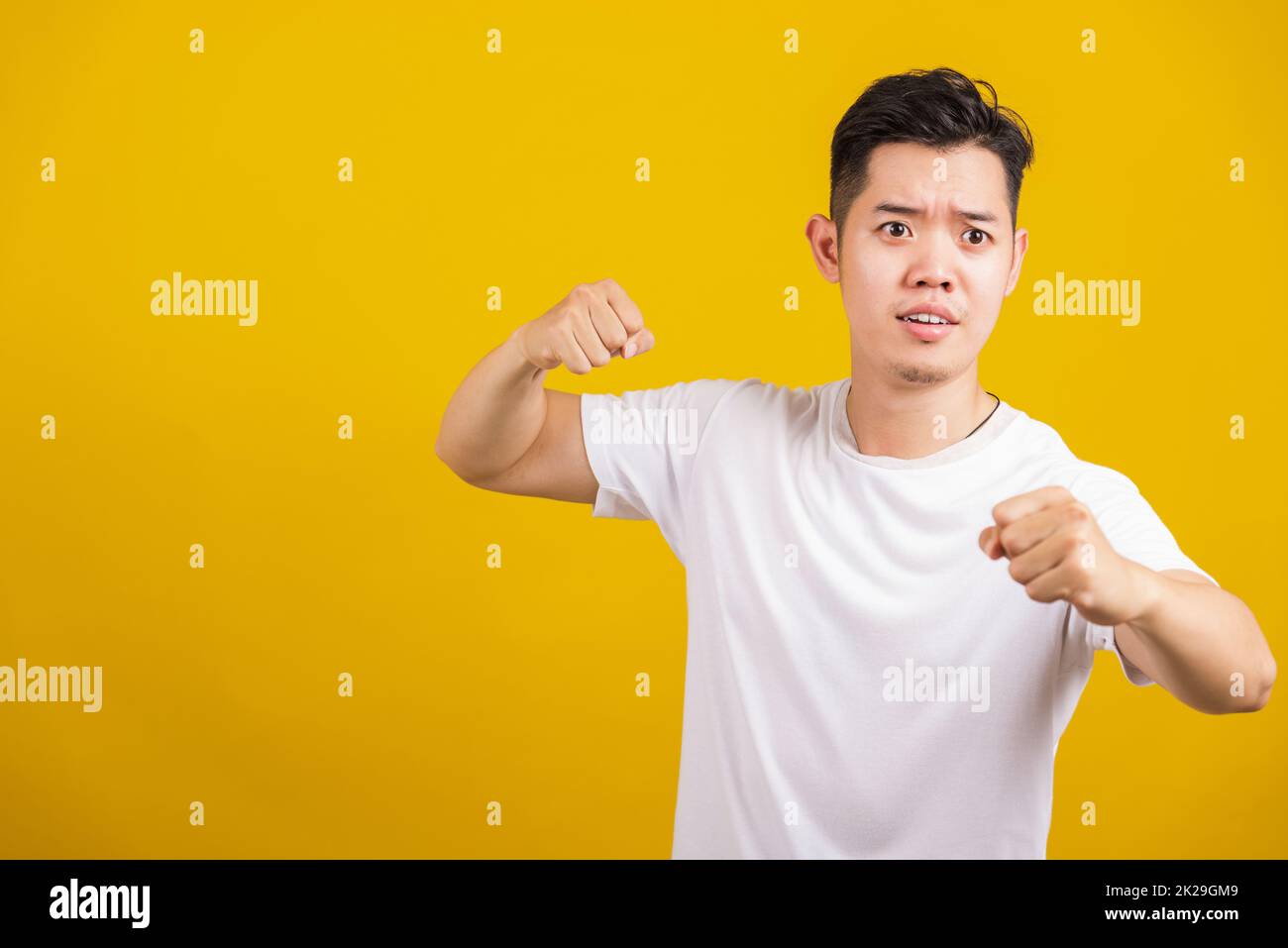 young angry man showing punch a clenches fist Stock Photo - Alamy