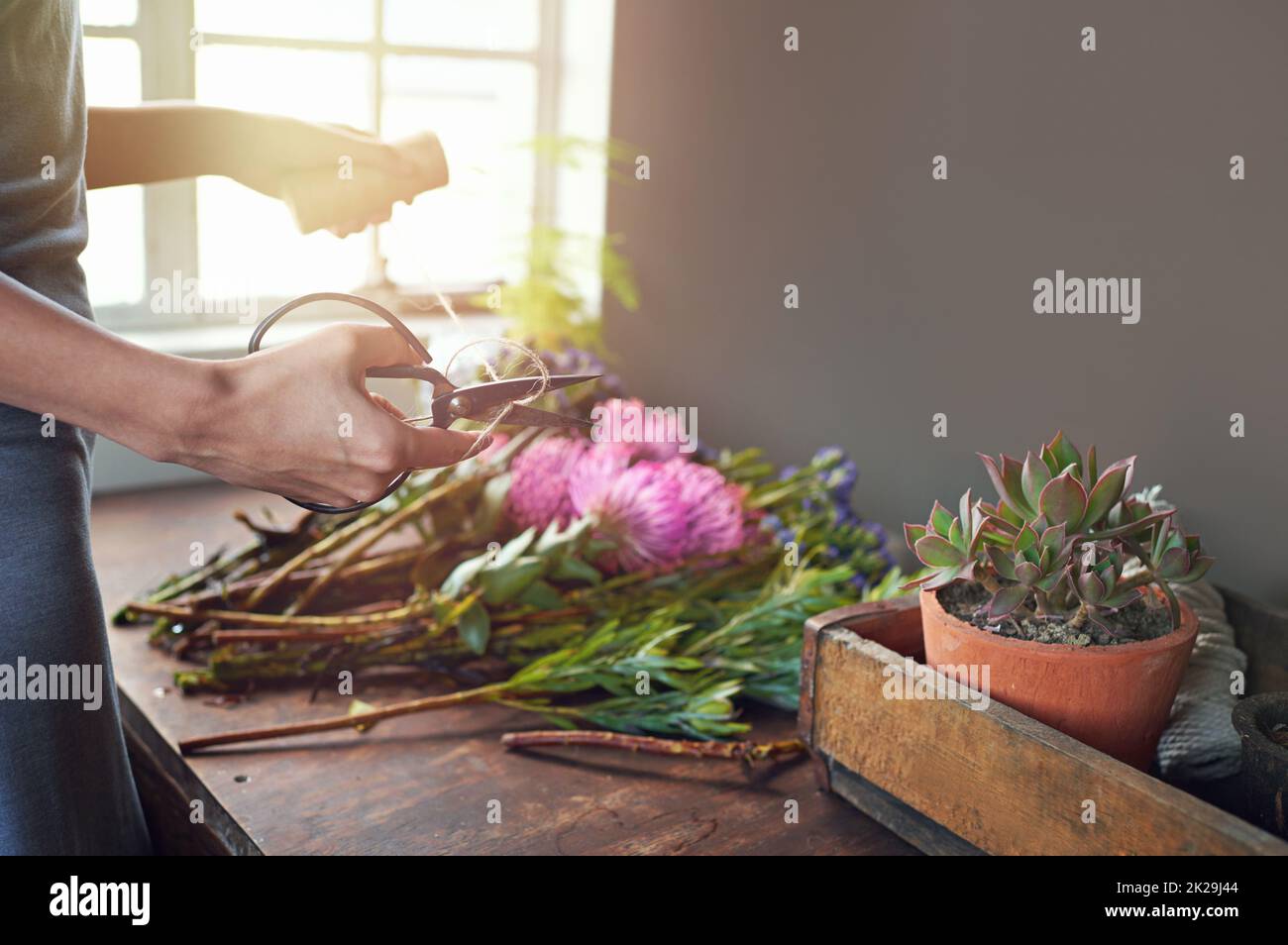 Creative minds are rarely tidy. a pretty floral bouquet being completed ...