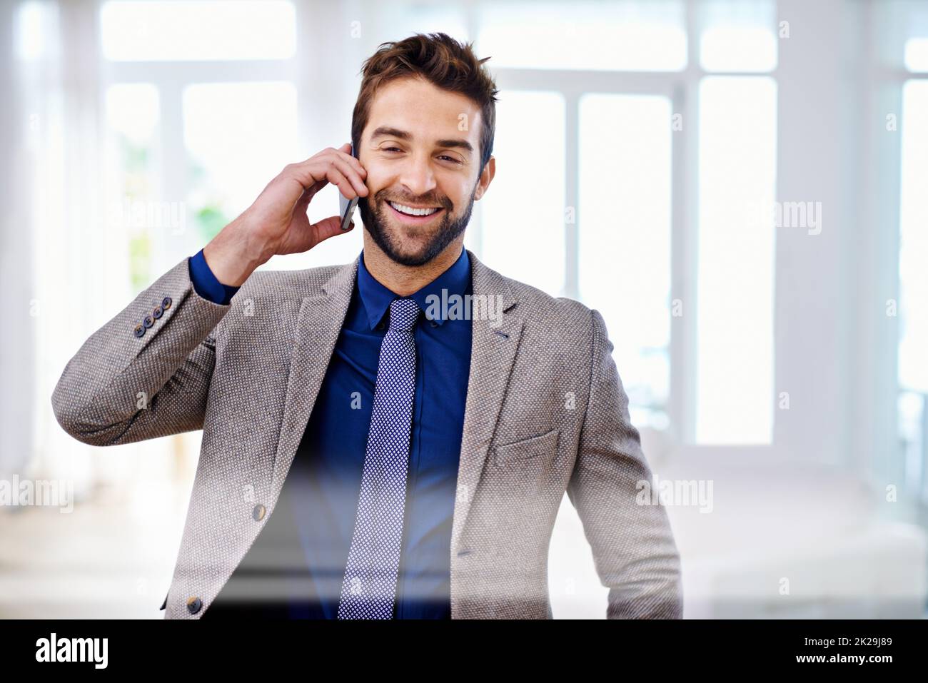 Hes got his finger on the pulse. A man in a contemporary suit talking ...